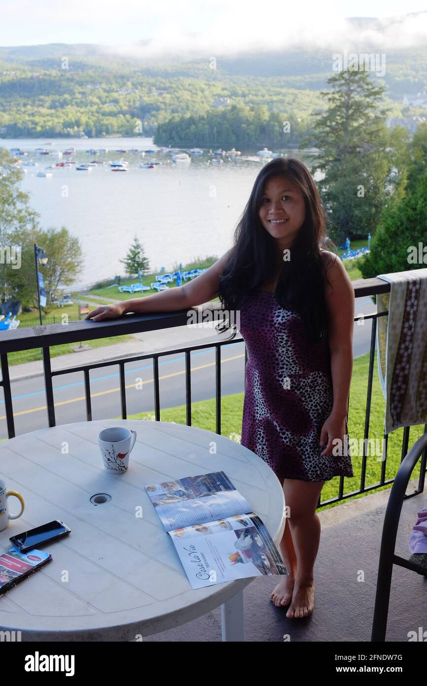 Beautiful Asian Filipino girl posing on a balcony overlooking Mont ...
