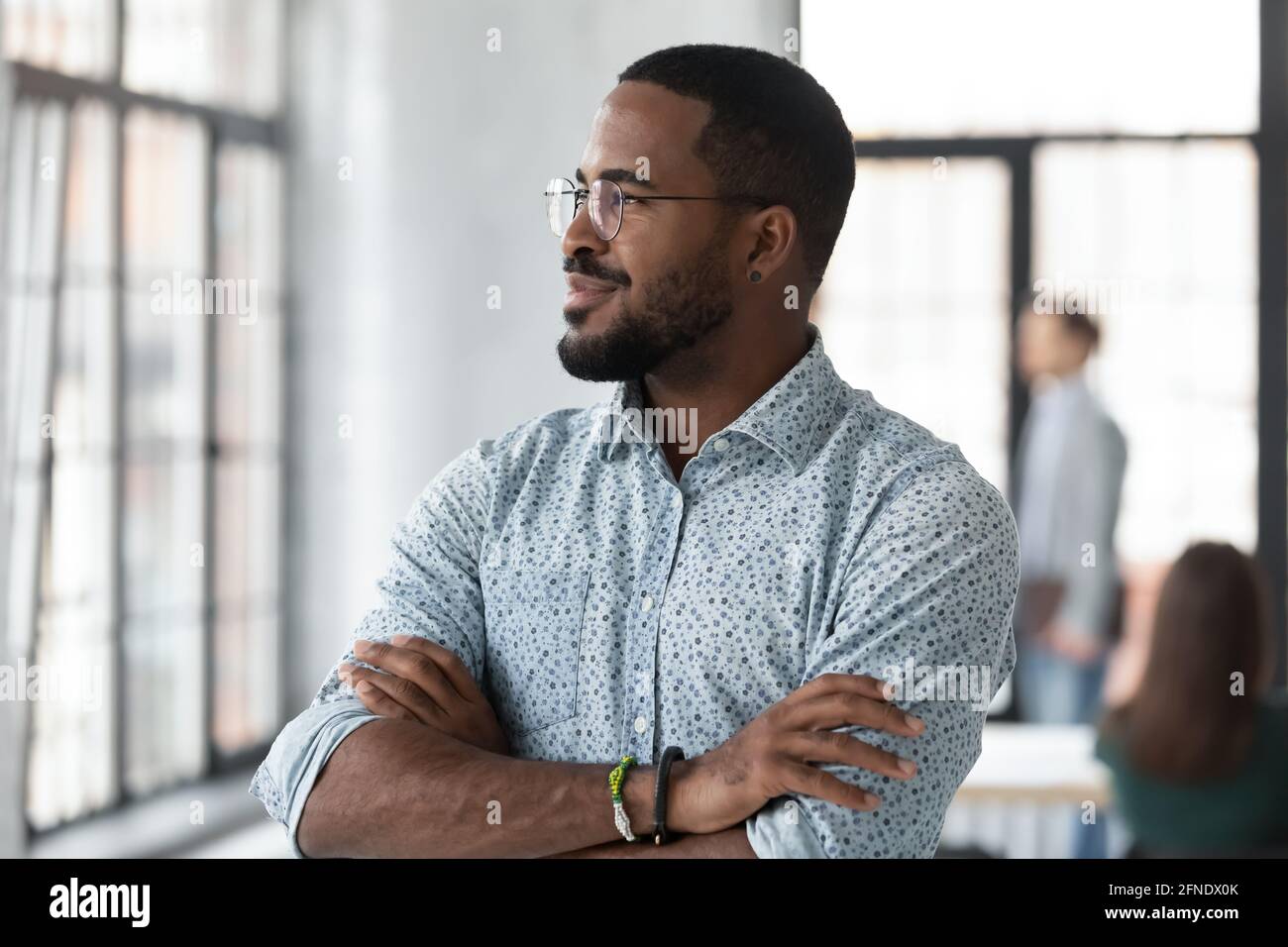 Successful African American startup leader looking out window Stock ...