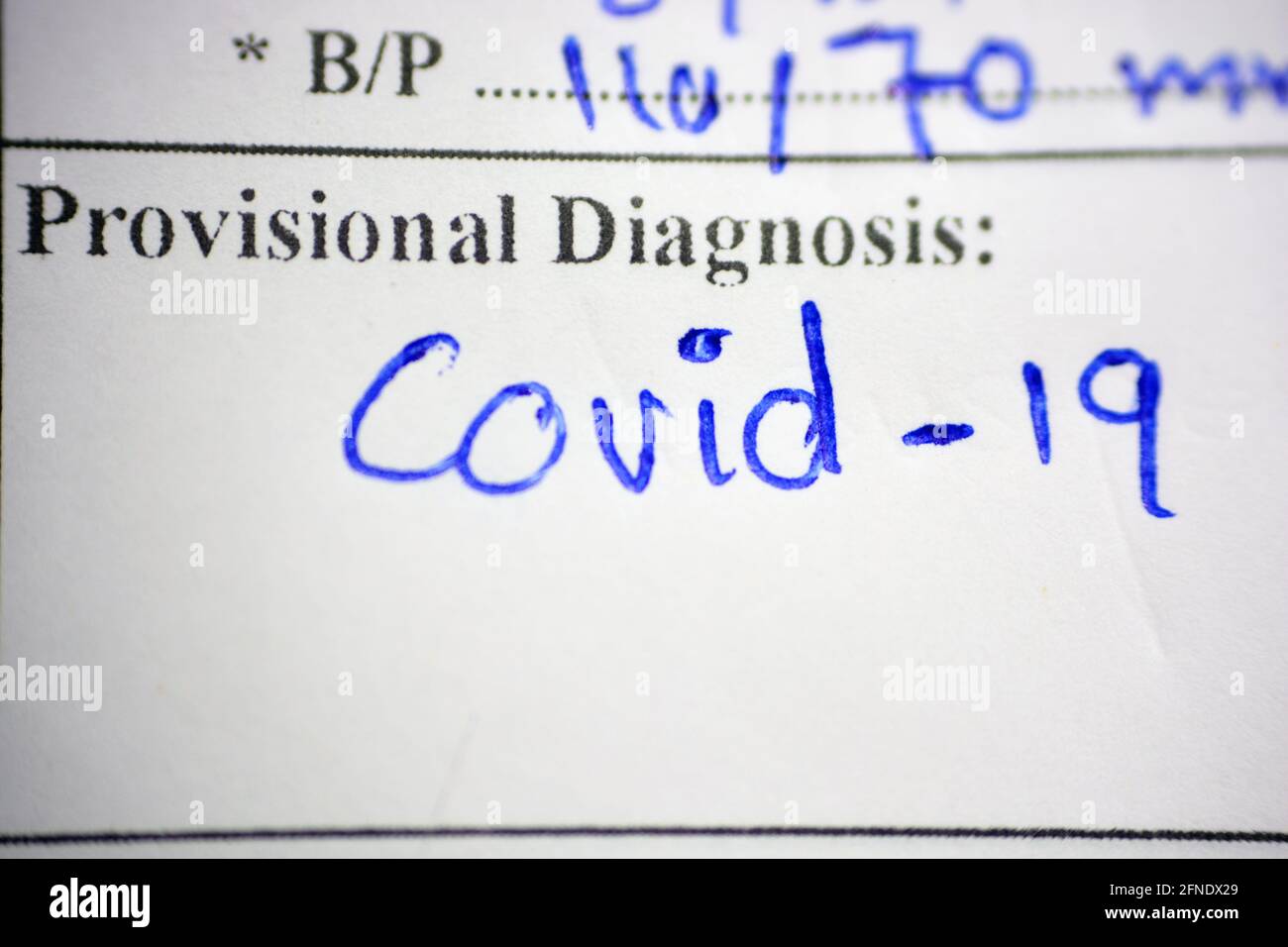 a selective focus a handwritten report with a provisional diagnosis ...