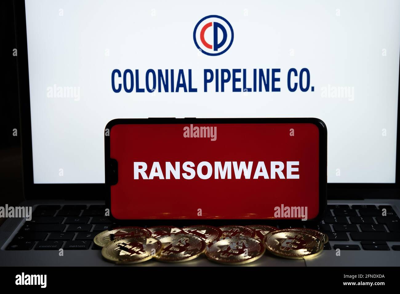 Colonial Pipeline Co logo on the blurred background and word RANSOMWARE ...