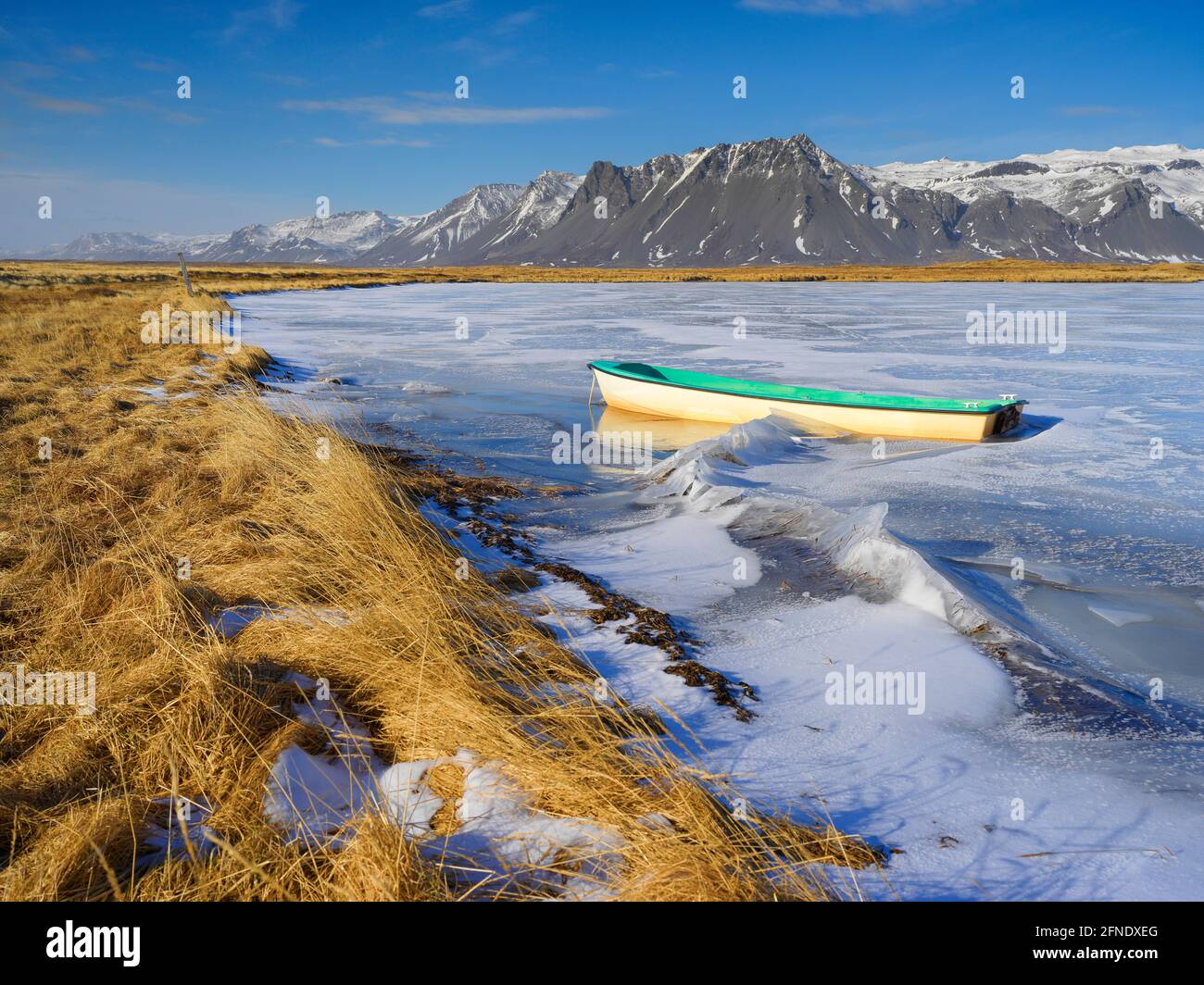 A rowing boat frozen in ice on a lake in Iceland Stock Photo - Alamy