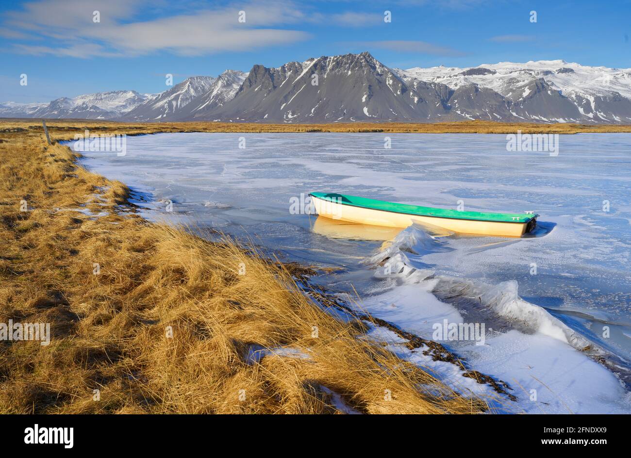A rowing boat stuck in ice on a frozen lake in Iceland Stock Photo - Alamy