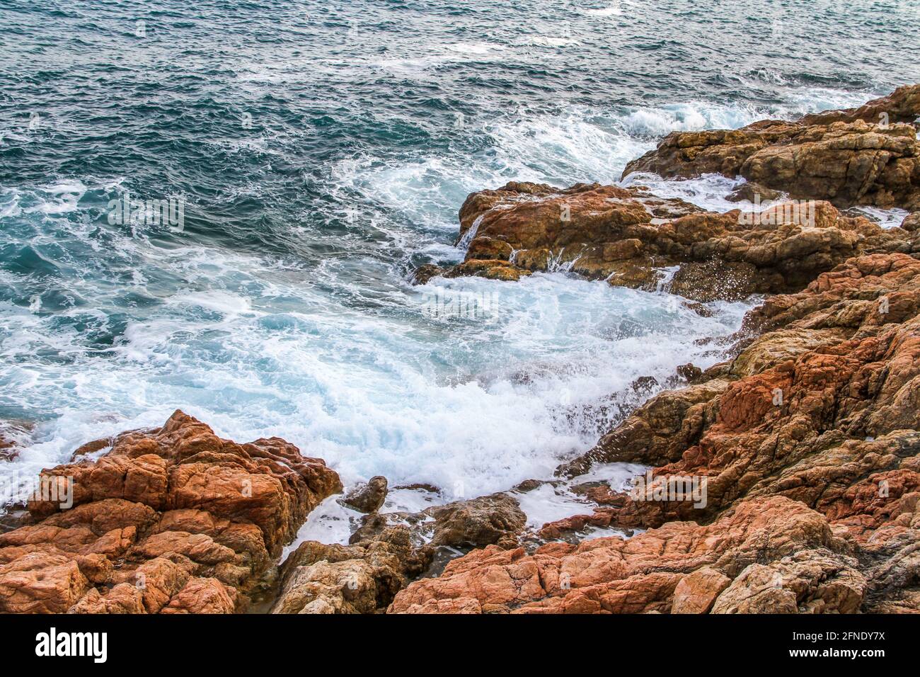 Tidal bore. Foamy blue waves crashing on coastal cliffs Stock Photo - Alamy