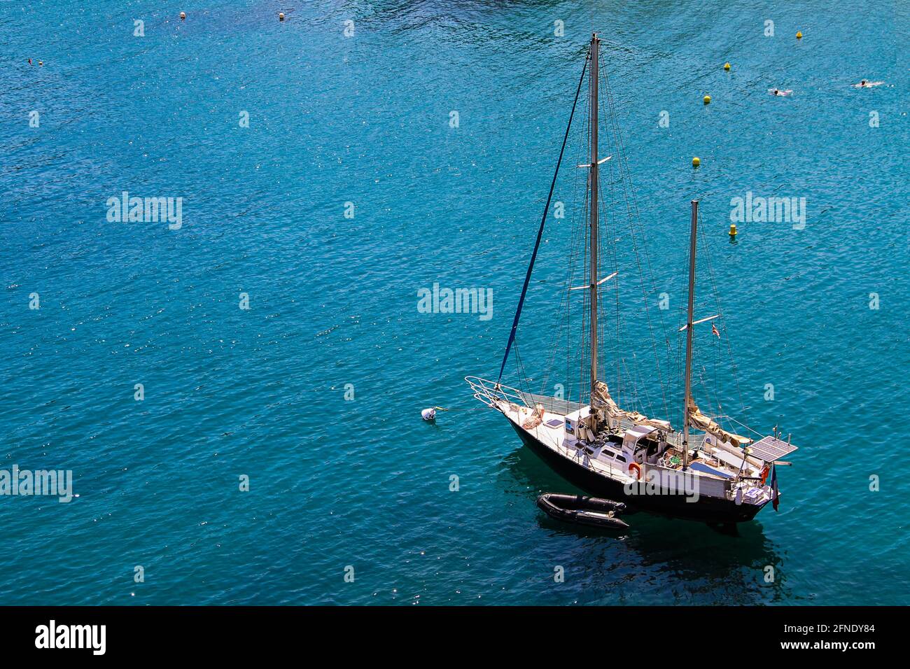 Two-masted sailing yacht anchored at sea Stock Photo - Alamy