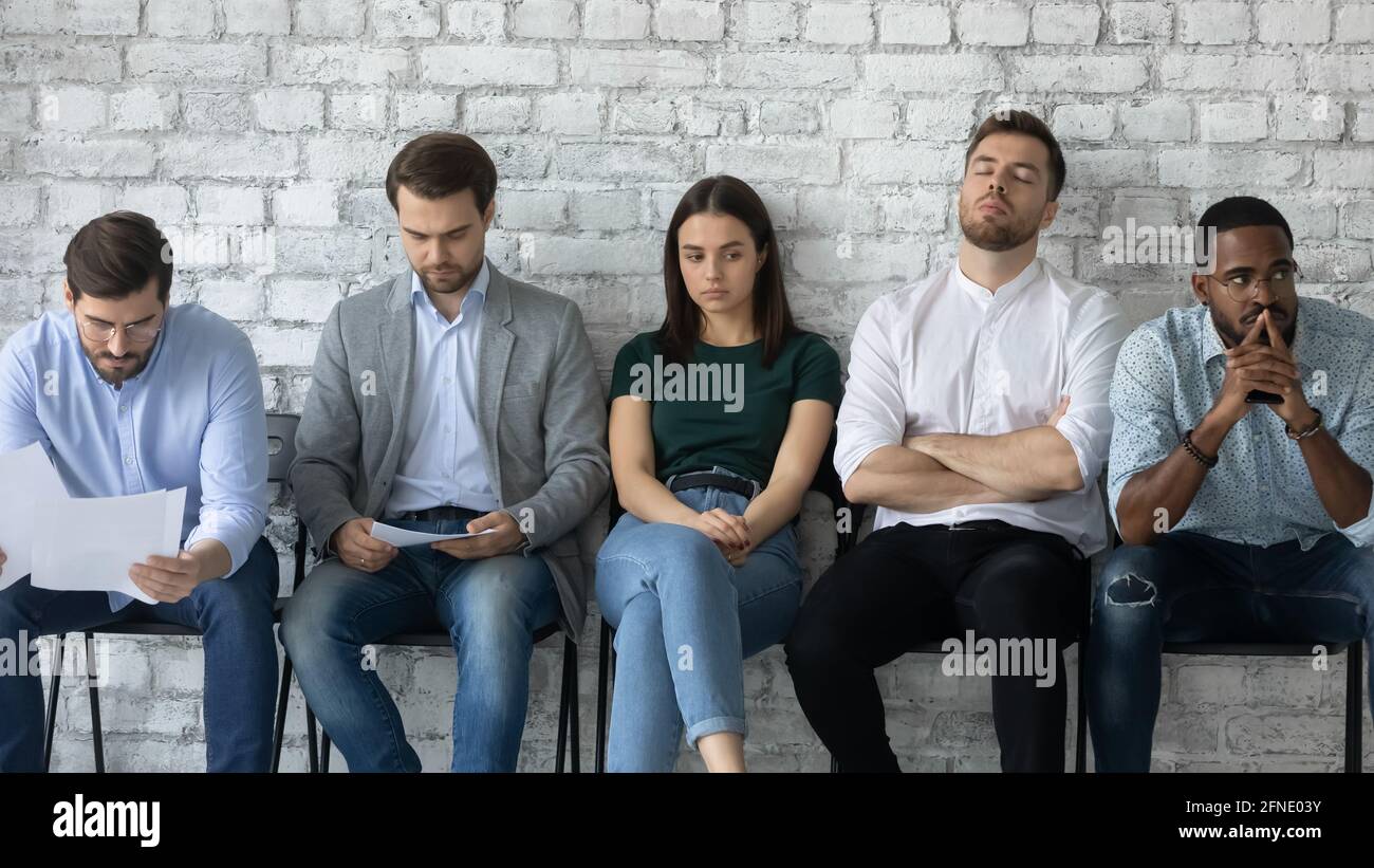 Tired job candidates waiting for interview far too long Stock Photo - Alamy