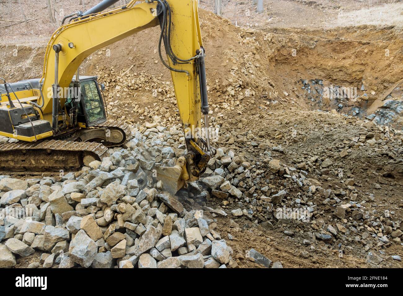 Heavy trucks with moving stone rock in a construction site on load ...