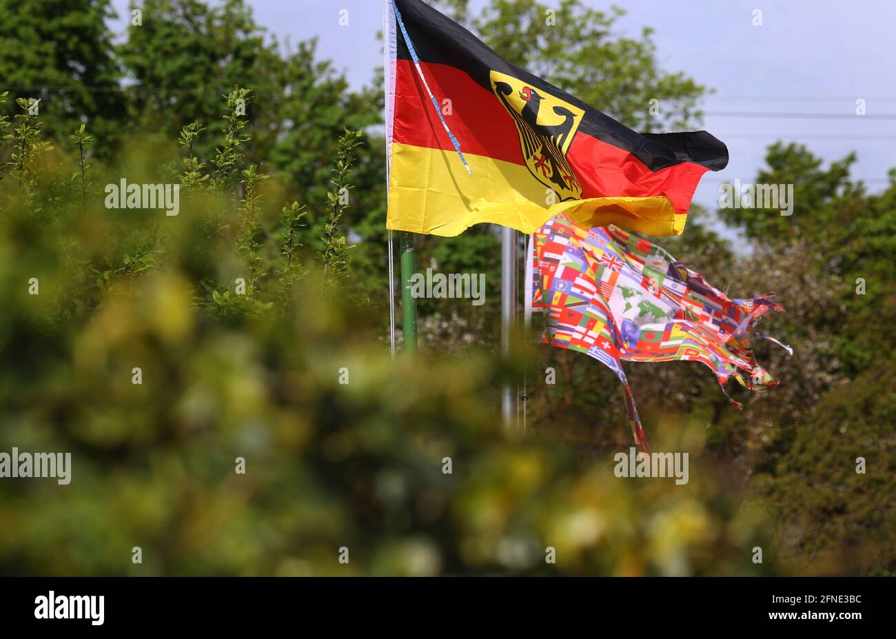 10 May 2021, Bavaria, Würzburg: A German flag and a flag with different ...