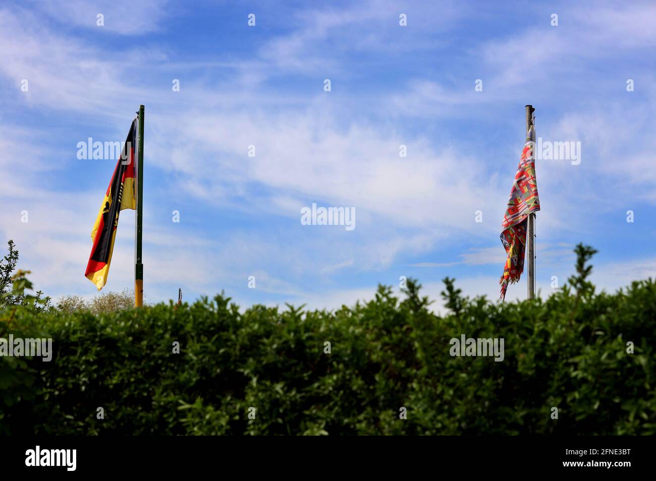 10 May 2021, Bavaria, Würzburg: A German flag and a flag with different ...