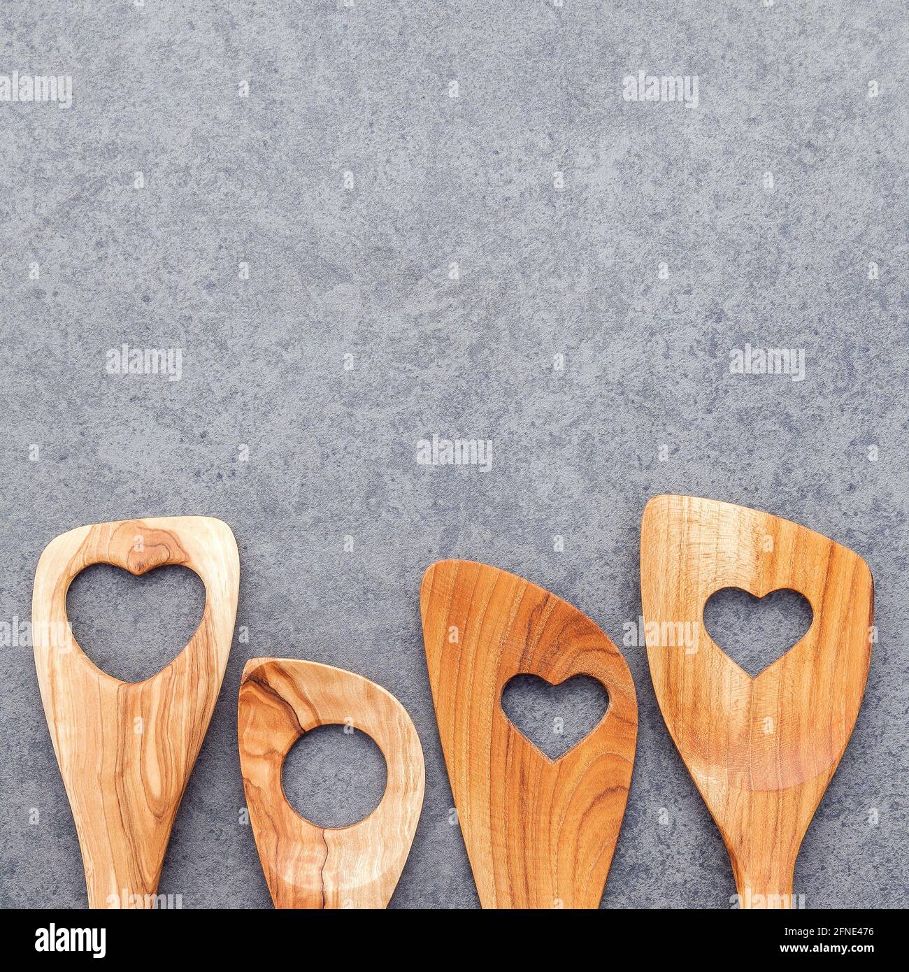 Various heart shape of wooden cooking utensils. Wooden spoons and ...
