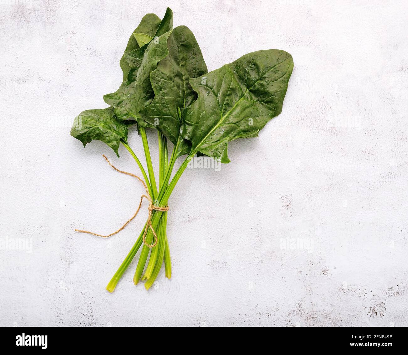 Fresh leaves of spinach setup on shabby concrete background with top ...