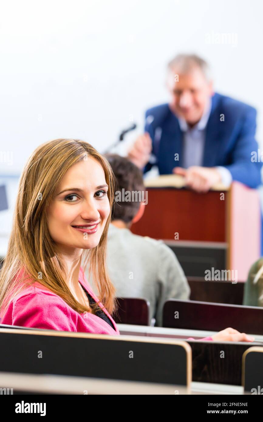 College professor giving lecture for students standing at desk Stock ...