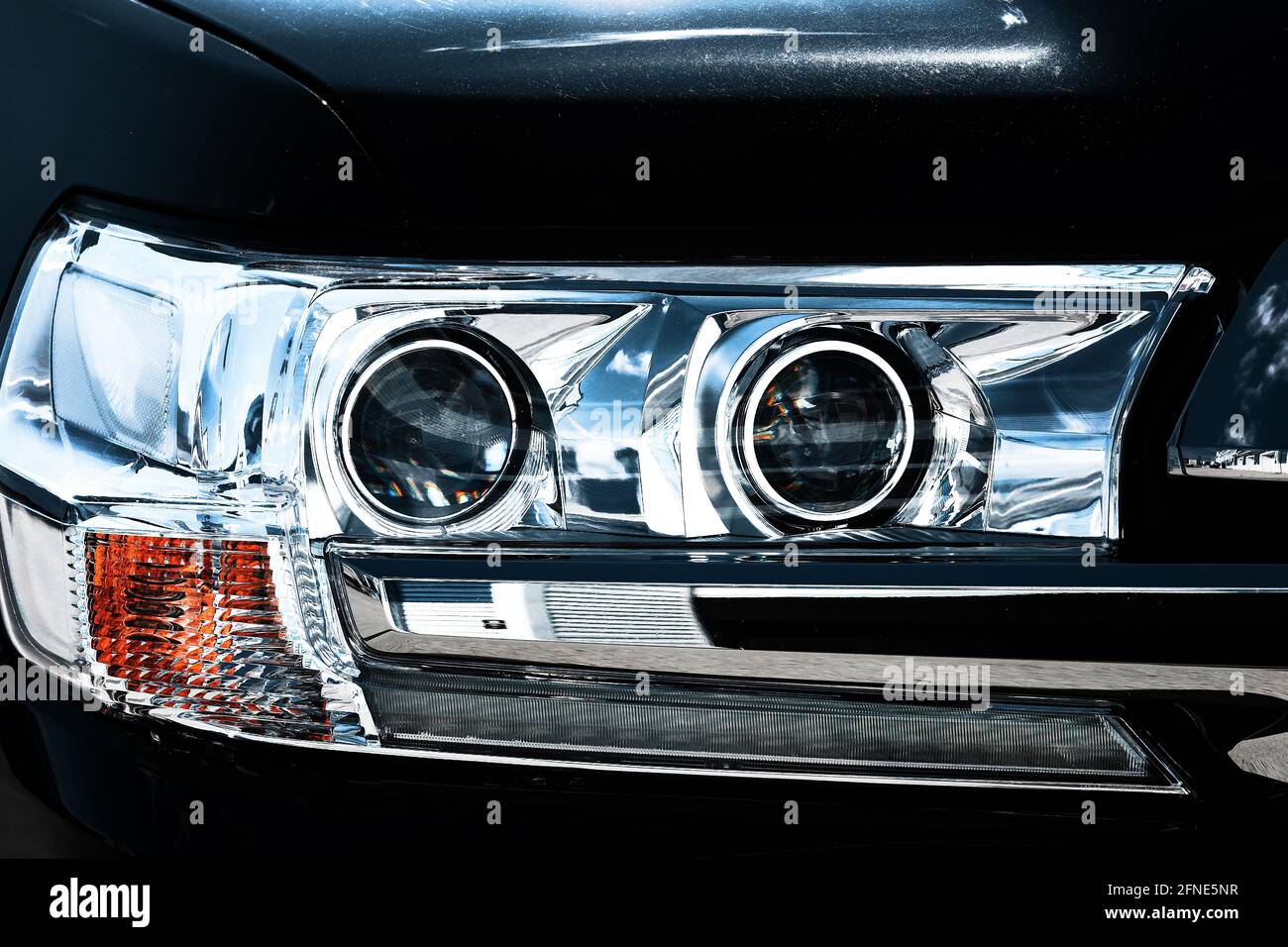 Crystal optics of the SUV. Front lights of a passenger car close-up. A ...