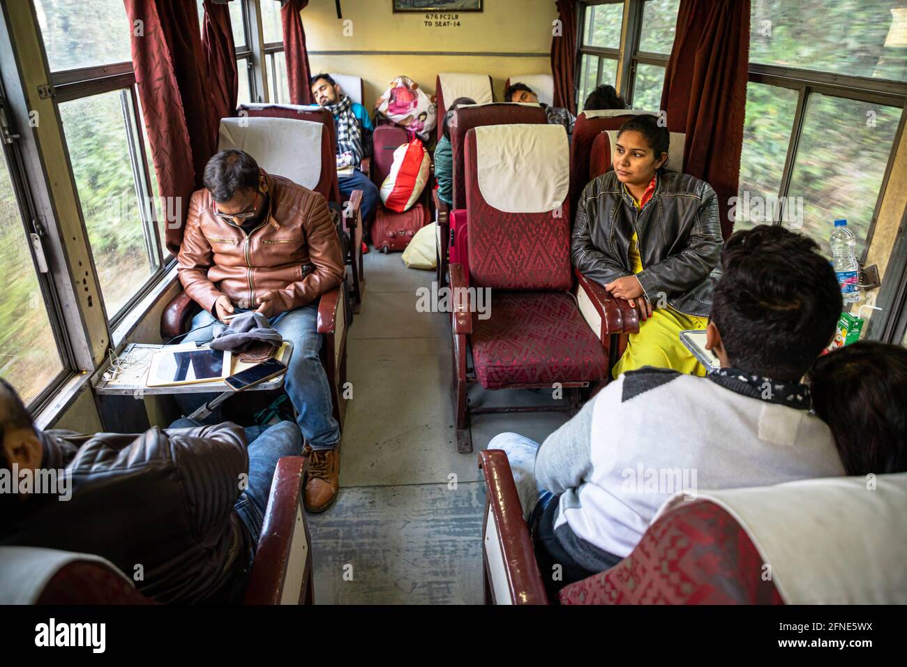 peoples are sitting inside the himalyan toy train Stock Photo - Alamy