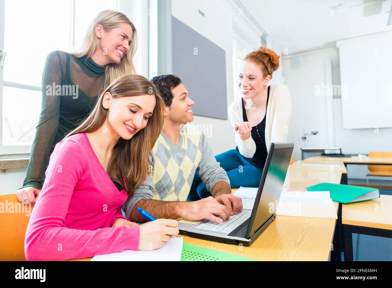 University college students using laptop for project team work learning ...