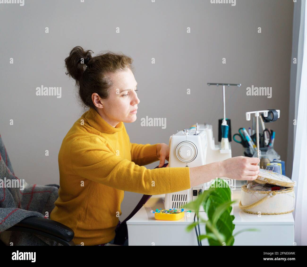 Creative hobby for moms. Side view of woman seamstress dressmaker in ...