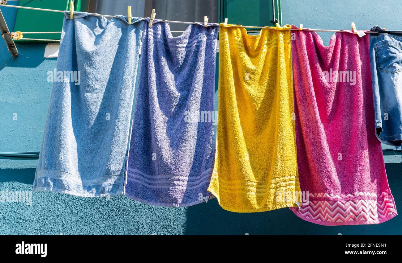 Colorful laundry on clothesline in front of blue house wall, Burano ...