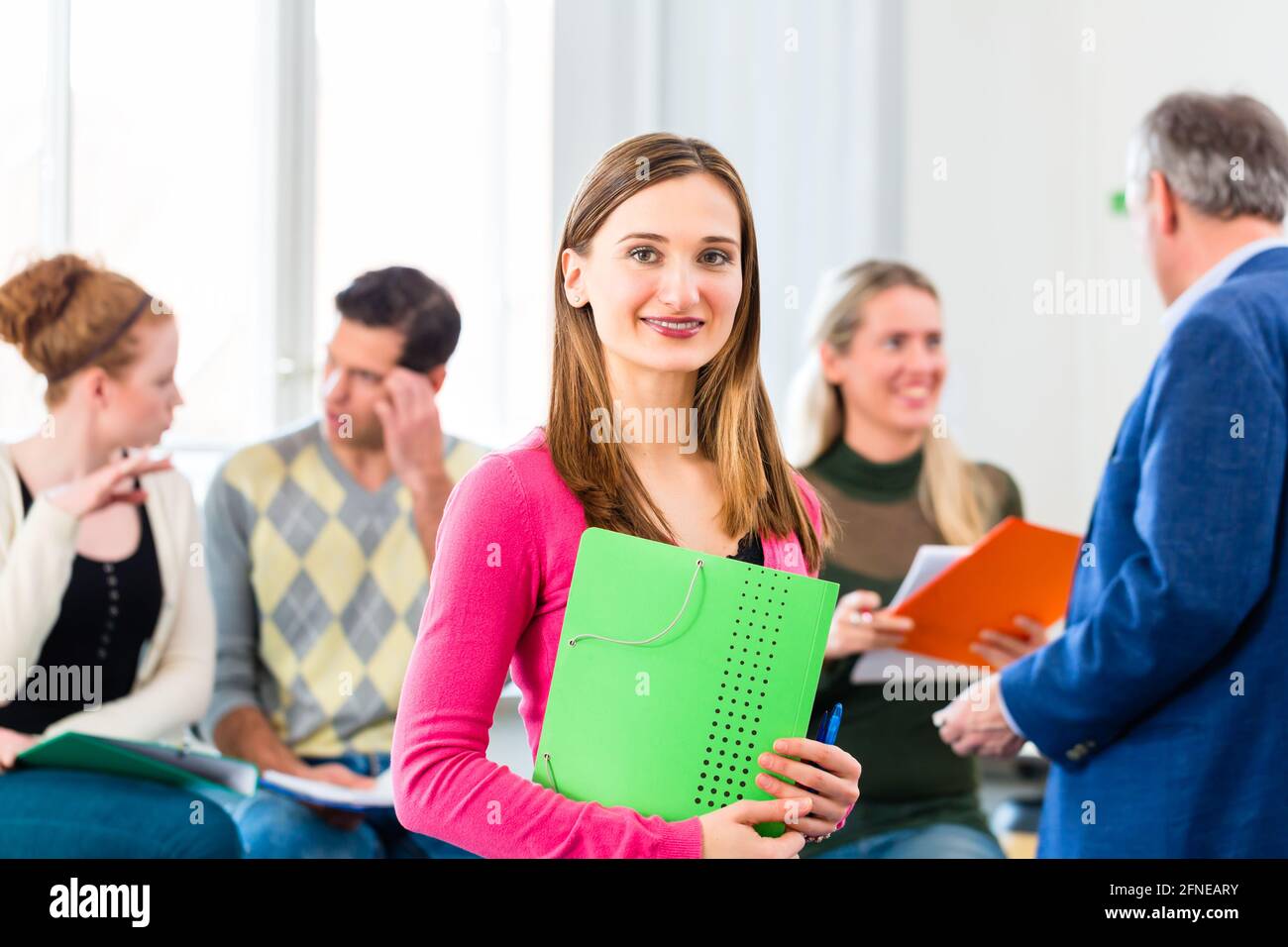 University college student standing in class room with professor Stock ...
