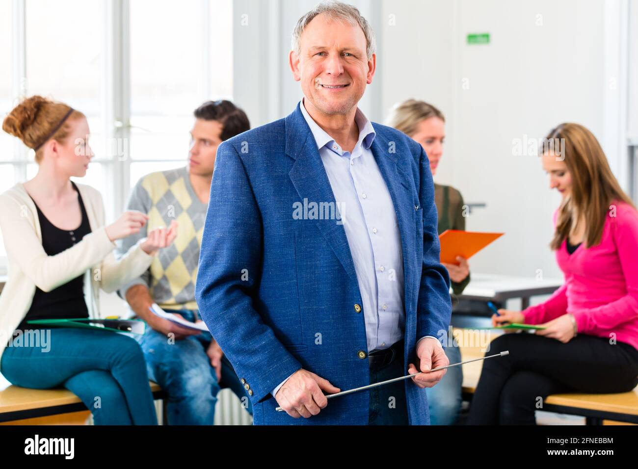 University college professor standing in class room Stock Photo - Alamy