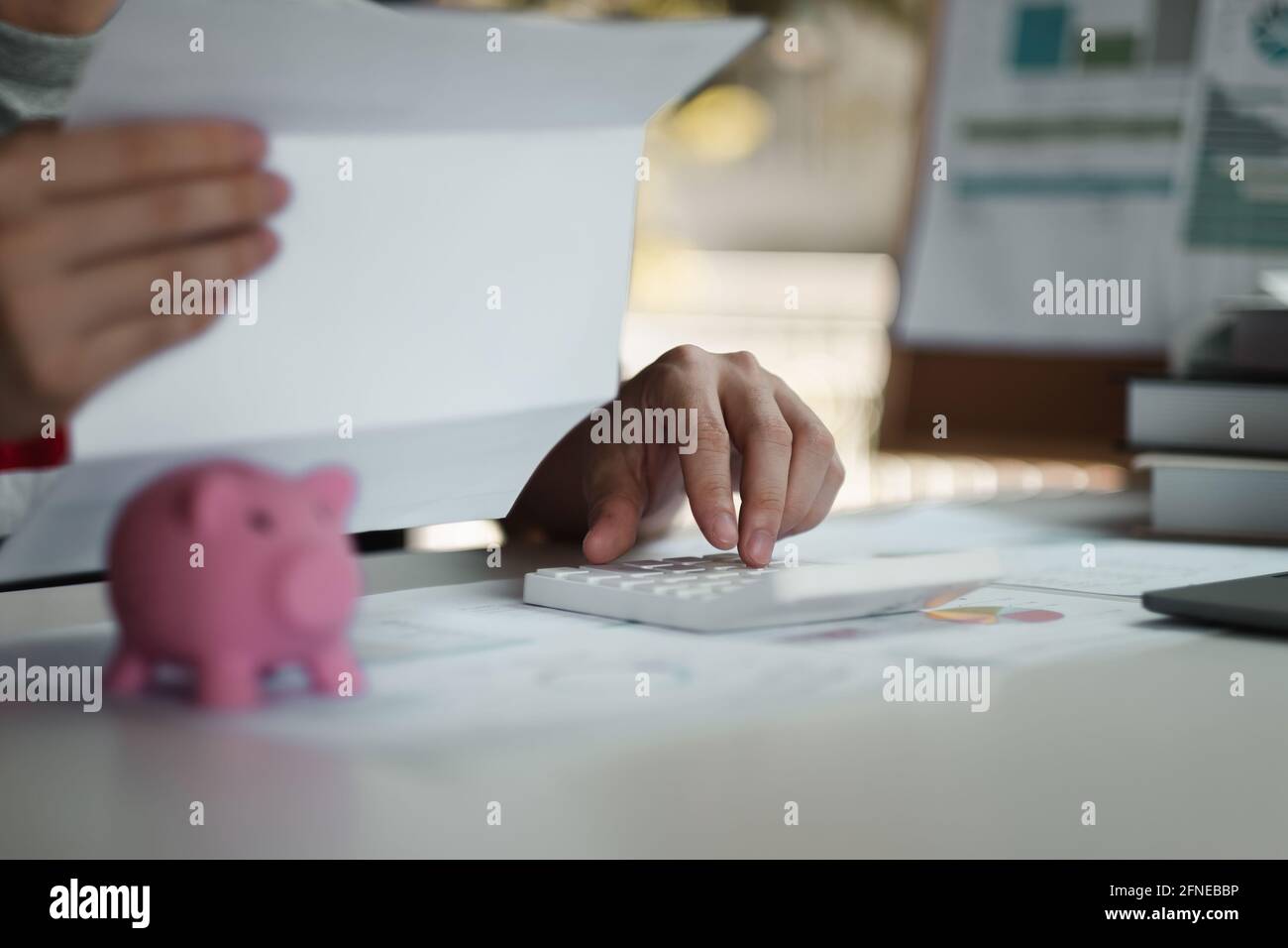 Woman calculating her Debt. woman hand calculating her monthly expenses ...