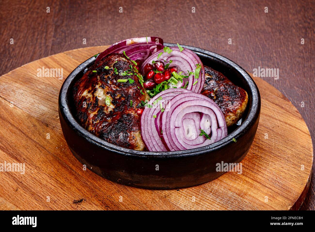 Roasted pork cutlet in the pot served onion Stock Photo - Alamy