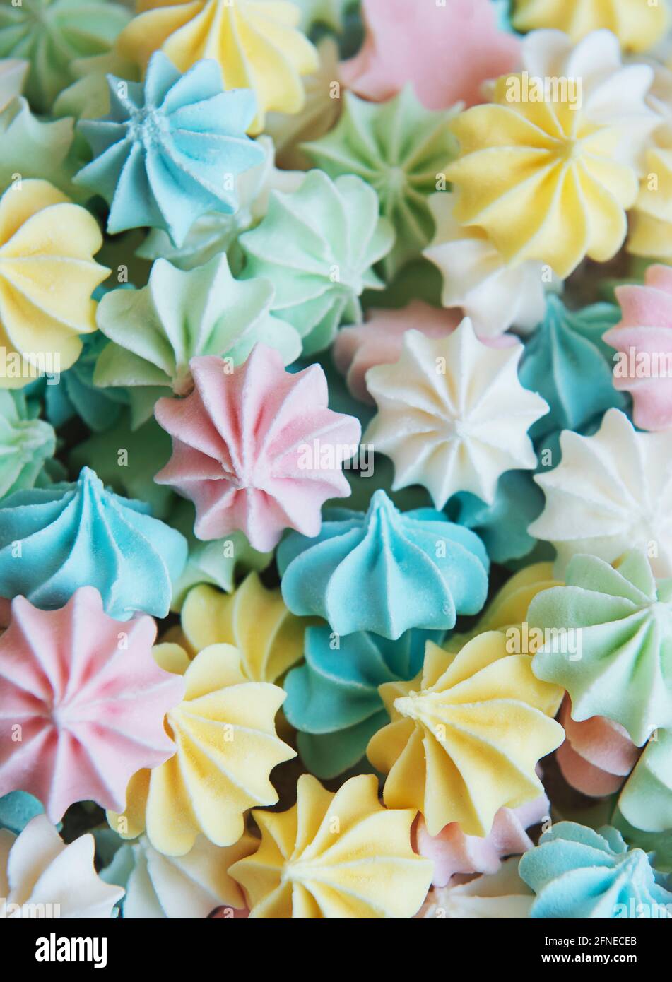 Close-up delicious meringue cookies pastel colors background. French ...
