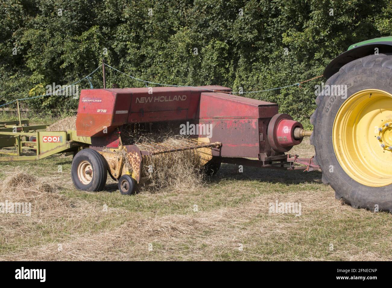 Haymaking, third stage, tractor pull with conventional baler and bale ...