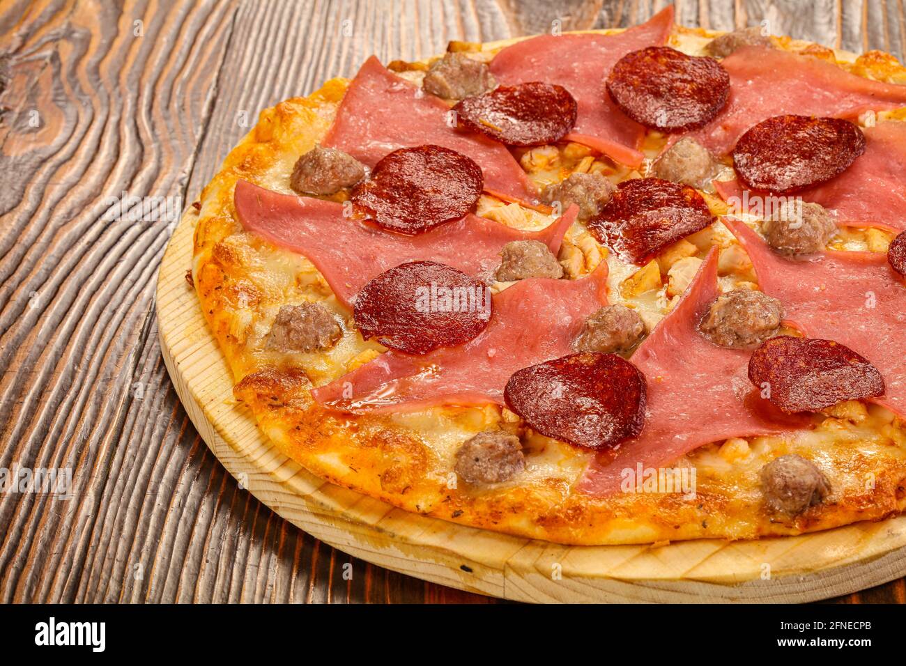 Pizza with ham, cheese and pepperoni Stock Photo - Alamy