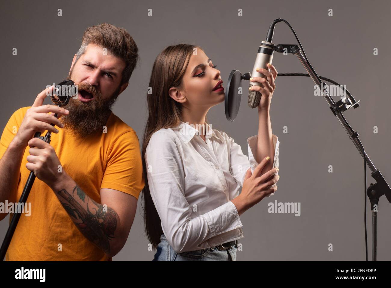 Karaoke singers couple. Woman and man singing with music microphone ...
