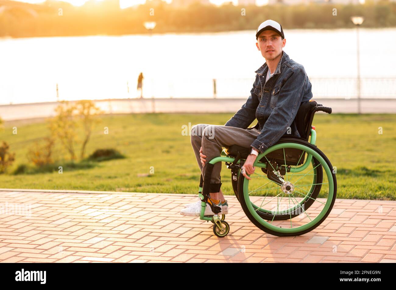 Invalid man sitting on a wheel chair and enjoying a walk outdoors Stock ...