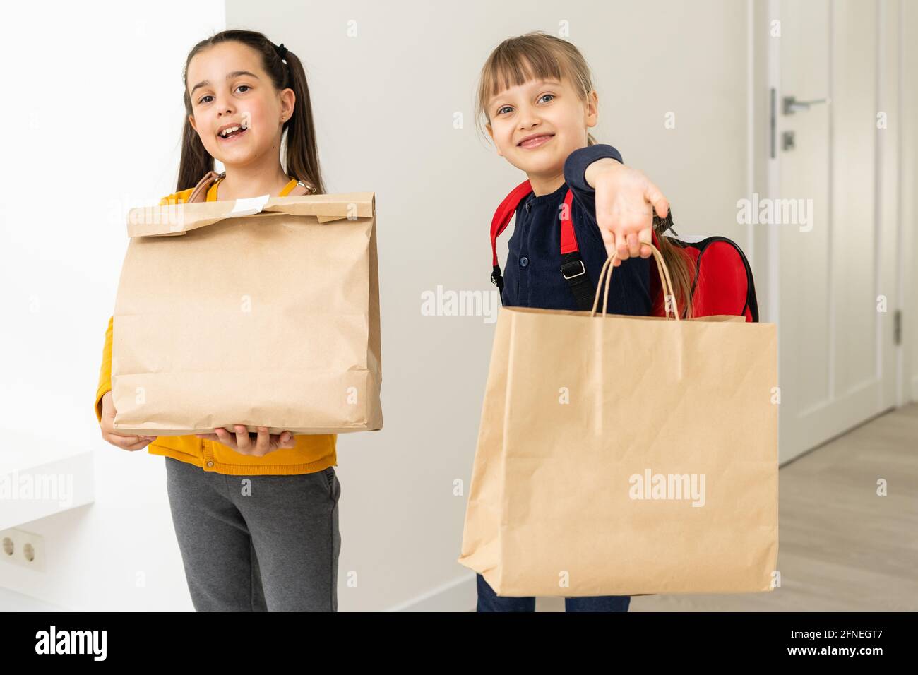 two schoolgirls with delivery packages Stock Photo - Alamy
