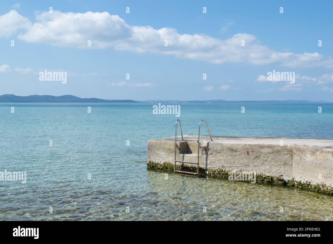 Small pier with stairs, vacation concept with blue Adriatic sea and ...