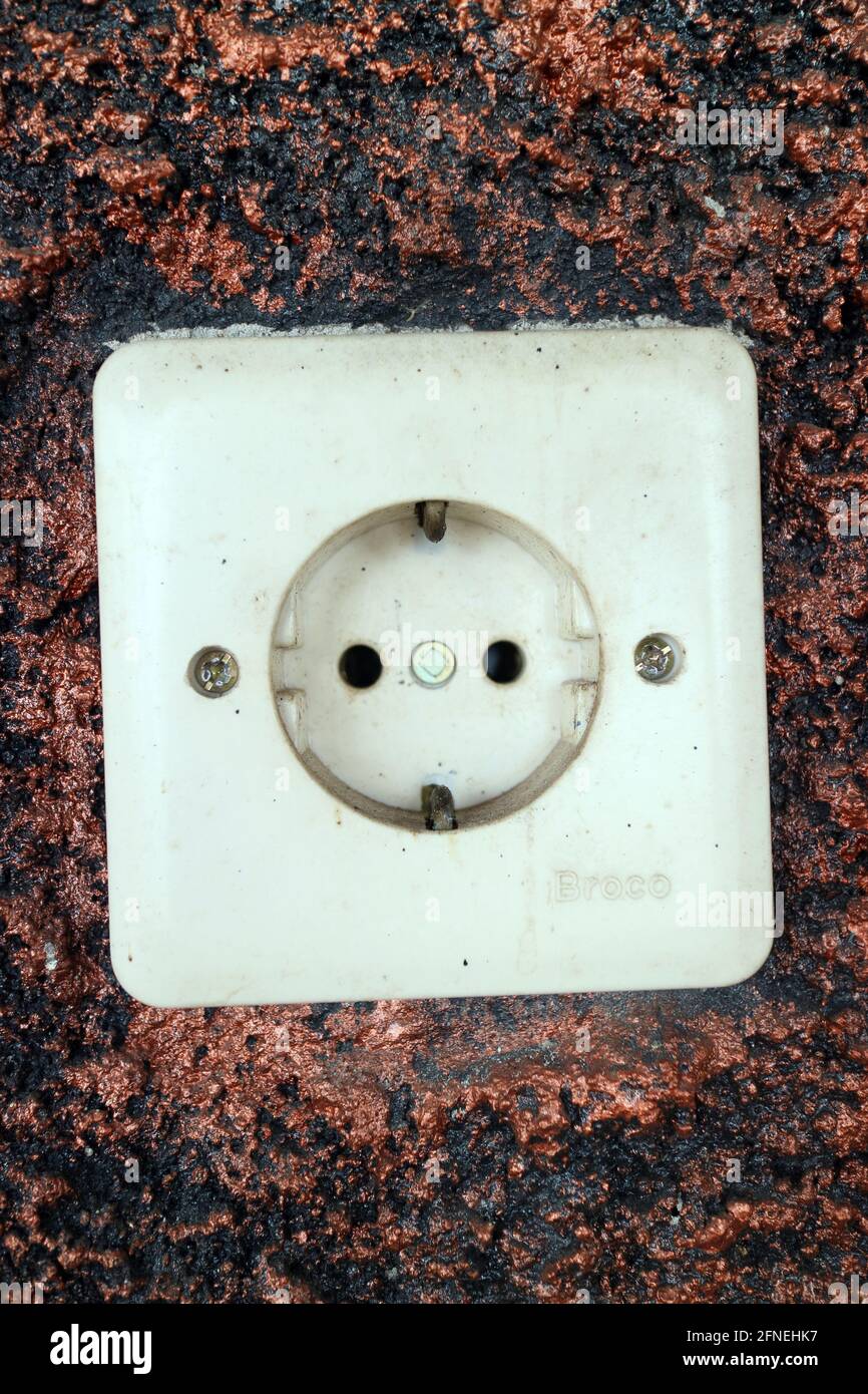white power plug stuck to the wall photo Stock Photo - Alamy