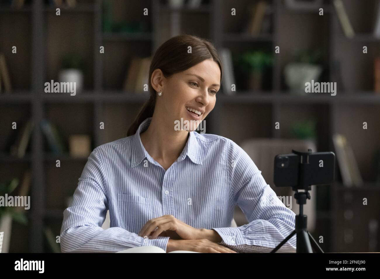 Happy young lady vlogger broadcast live from home using cell Stock Photo - Alamy