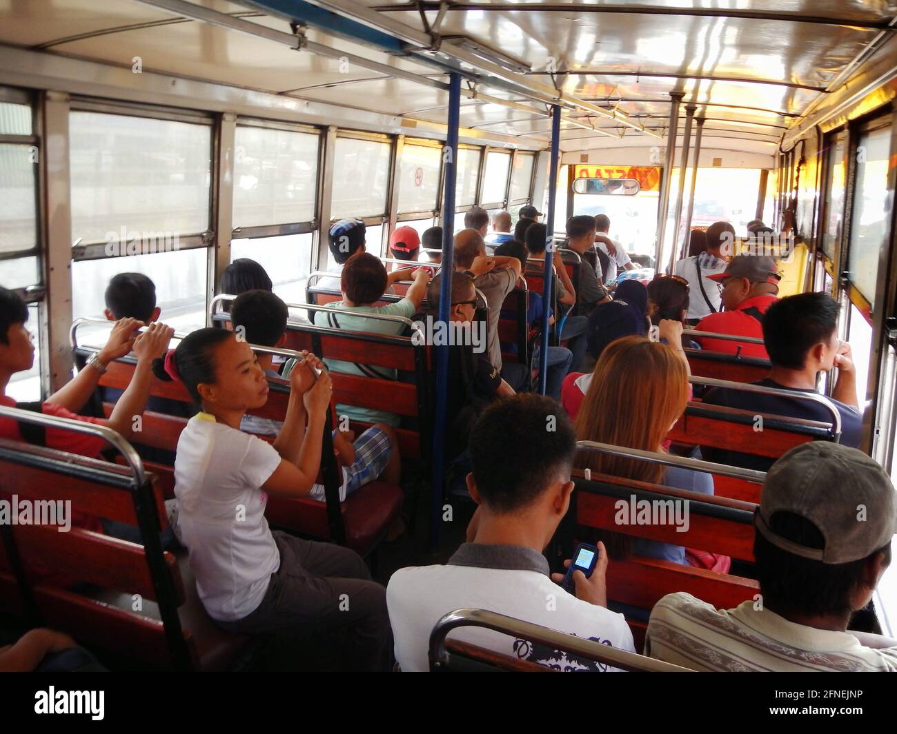 Commuters riding on an aircon bus in Novaliches, Manila, Philippines ...