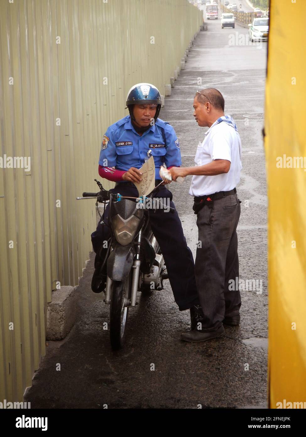 Policemen or security guards chatting close to a motorcycle in ...