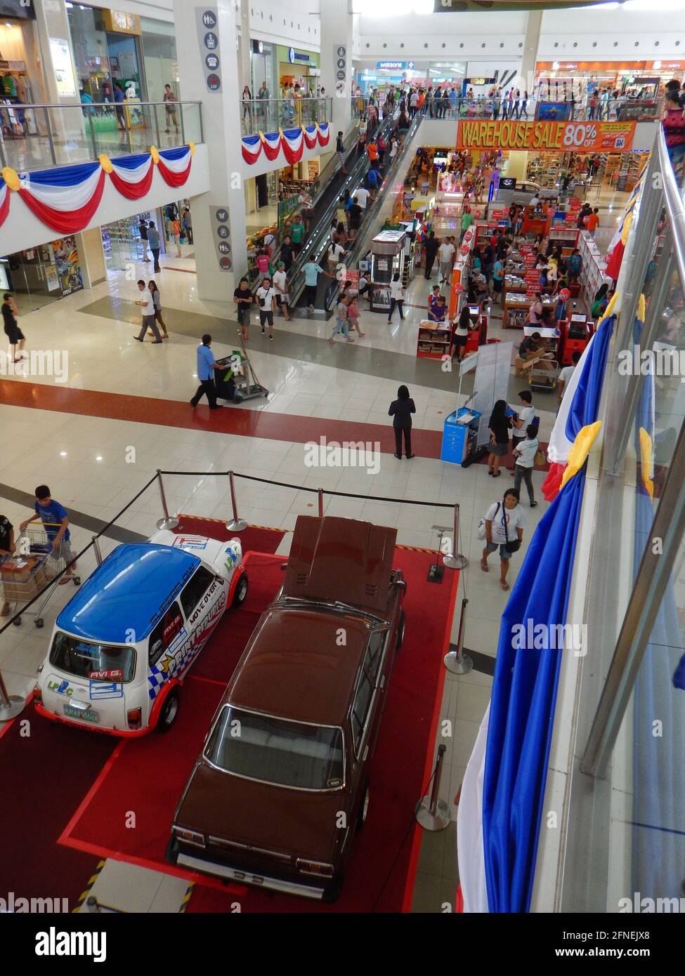Cars and customers in an indoors mall in Novaliches, Manila ...