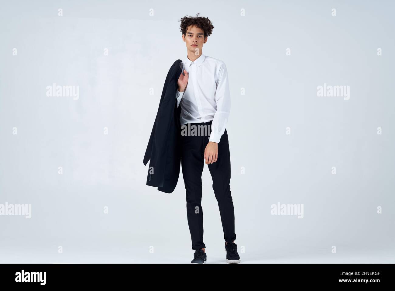 man with a jacket in his hands in full growth posing fashion self ...