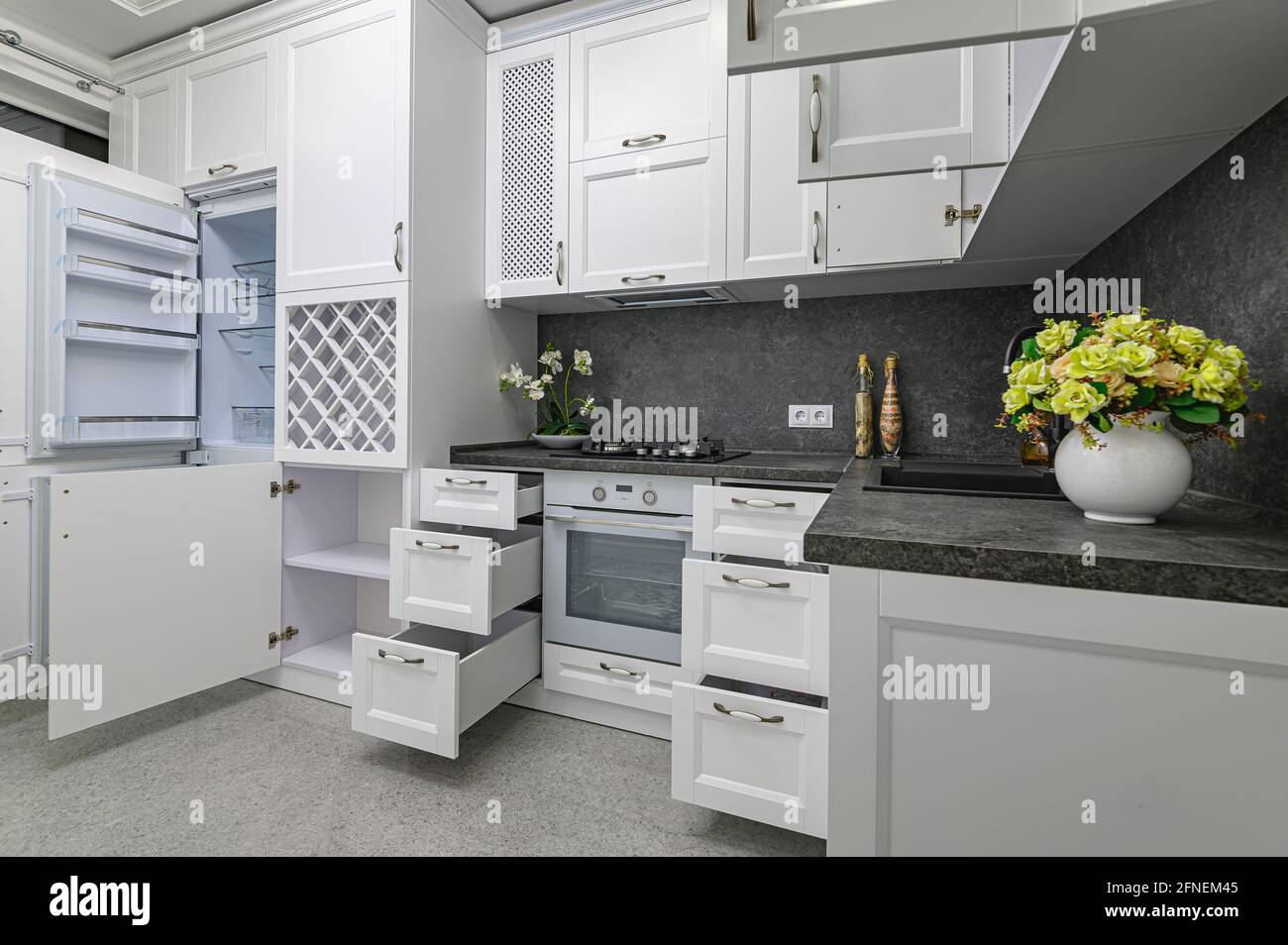 Open doors and drawers open at modern white kitchen Stock Photo - Alamy