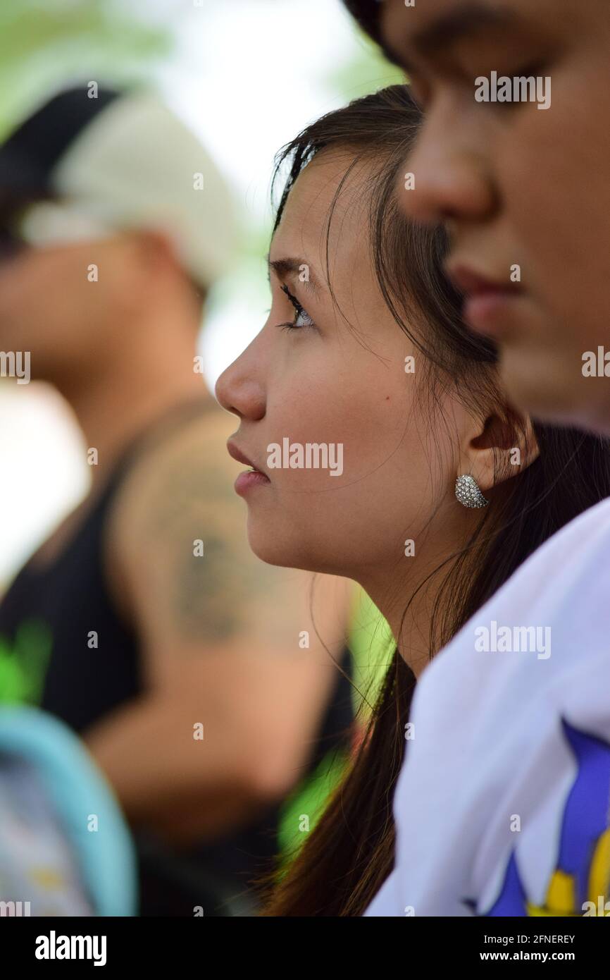Beautiful young Filipino woman looking up while celebrating Philippines ...