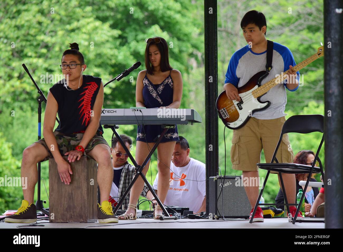 Three Filipino teenagers performers playing music on stage at ...