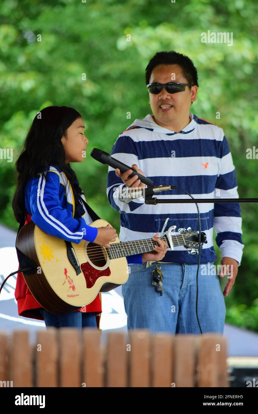 Young Filipino girl sings and plays the guitar on stage at Philippines ...