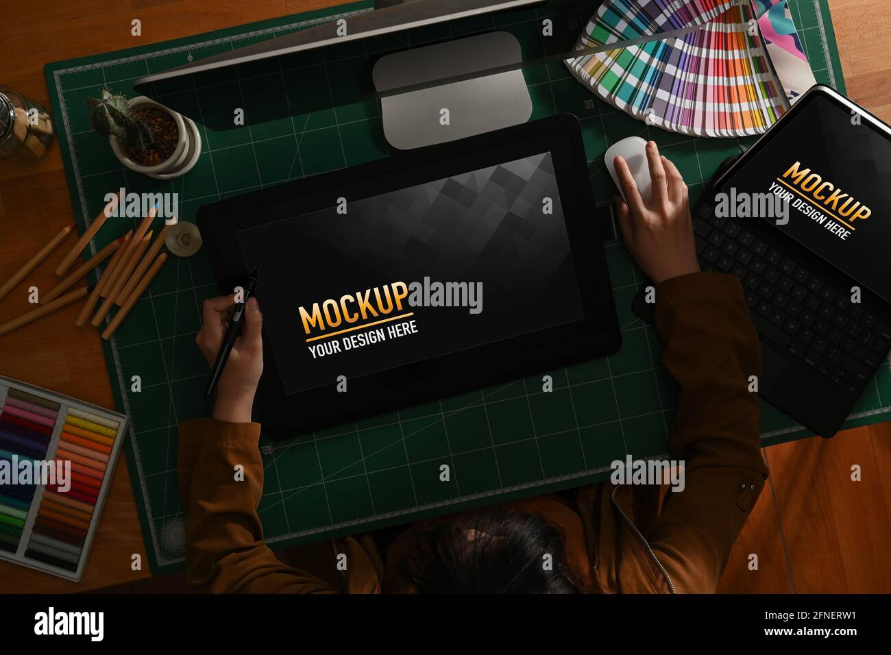 Overhead shot of female graphic designer working with mock up drawing ...