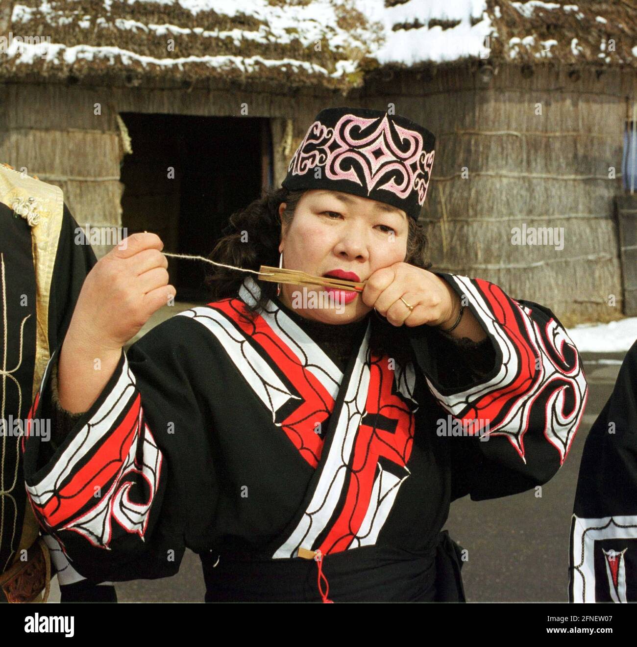 A Japanese indigenous woman (Ainu) plays a traditional musical ...