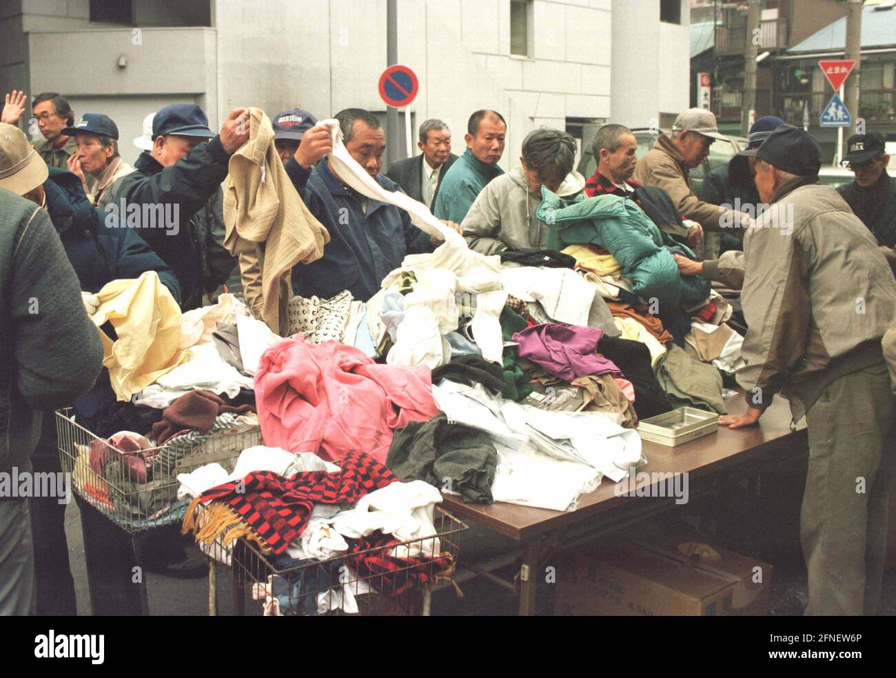 Homeless people at clothing distribution in Yokohama. [automated ...