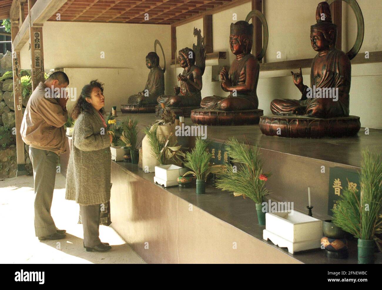 Japanese at a prayer site at Kinryu Jigoku Onsen in the Beppu hot ...