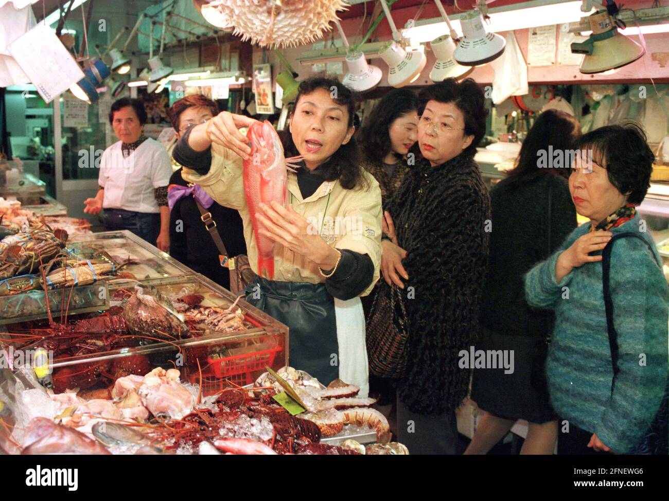 Vendor and customers at the women-run fish market in Naha, Okinawa ...