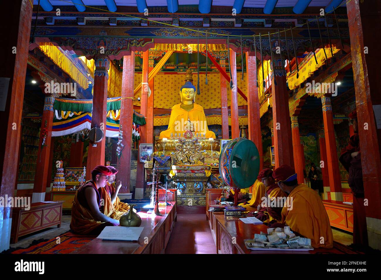 View of Buddha statue in the main temple hall, with prayer session in ...