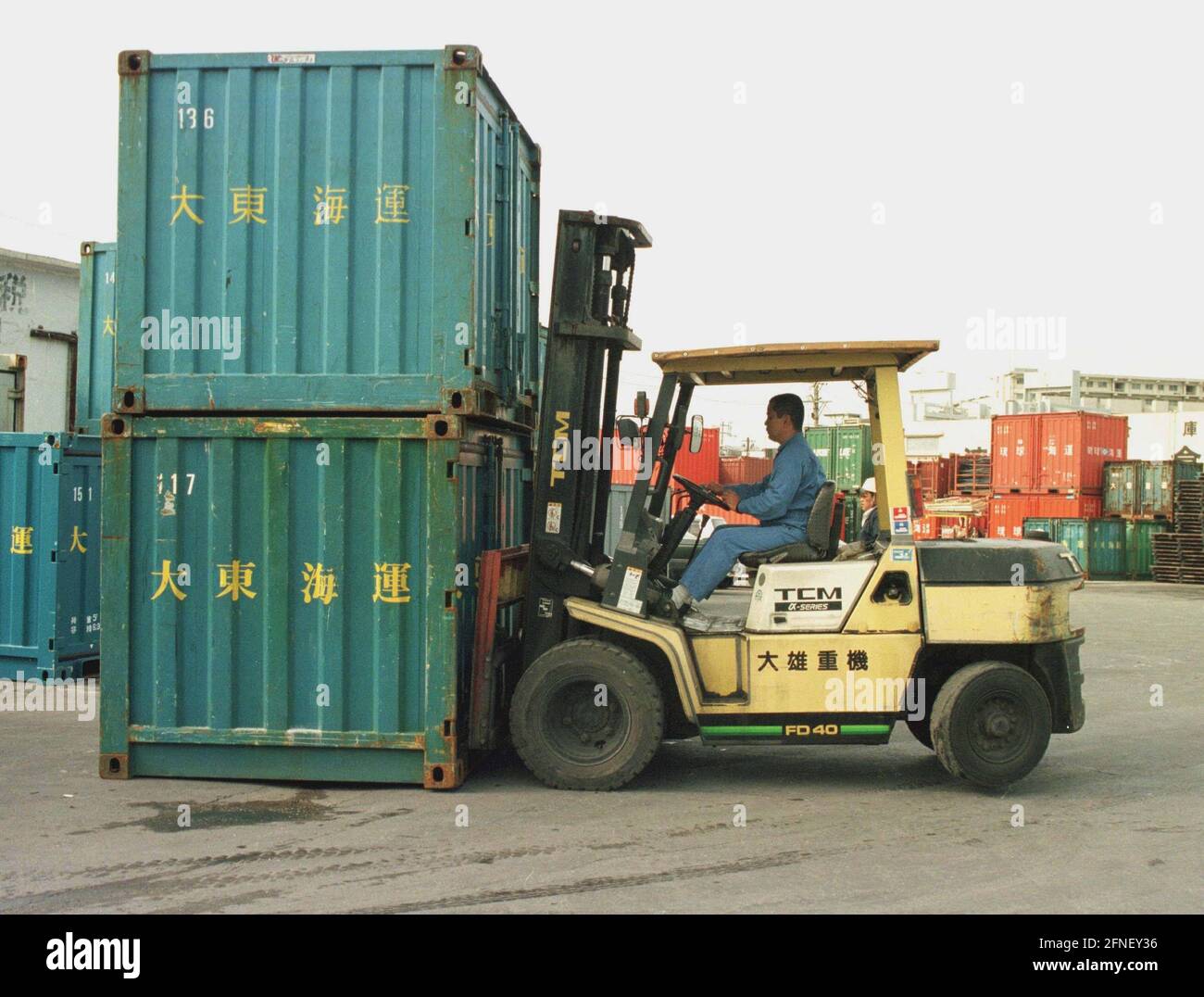 Forklift loading containers at the port of Naha, Okinawa. [automated ...