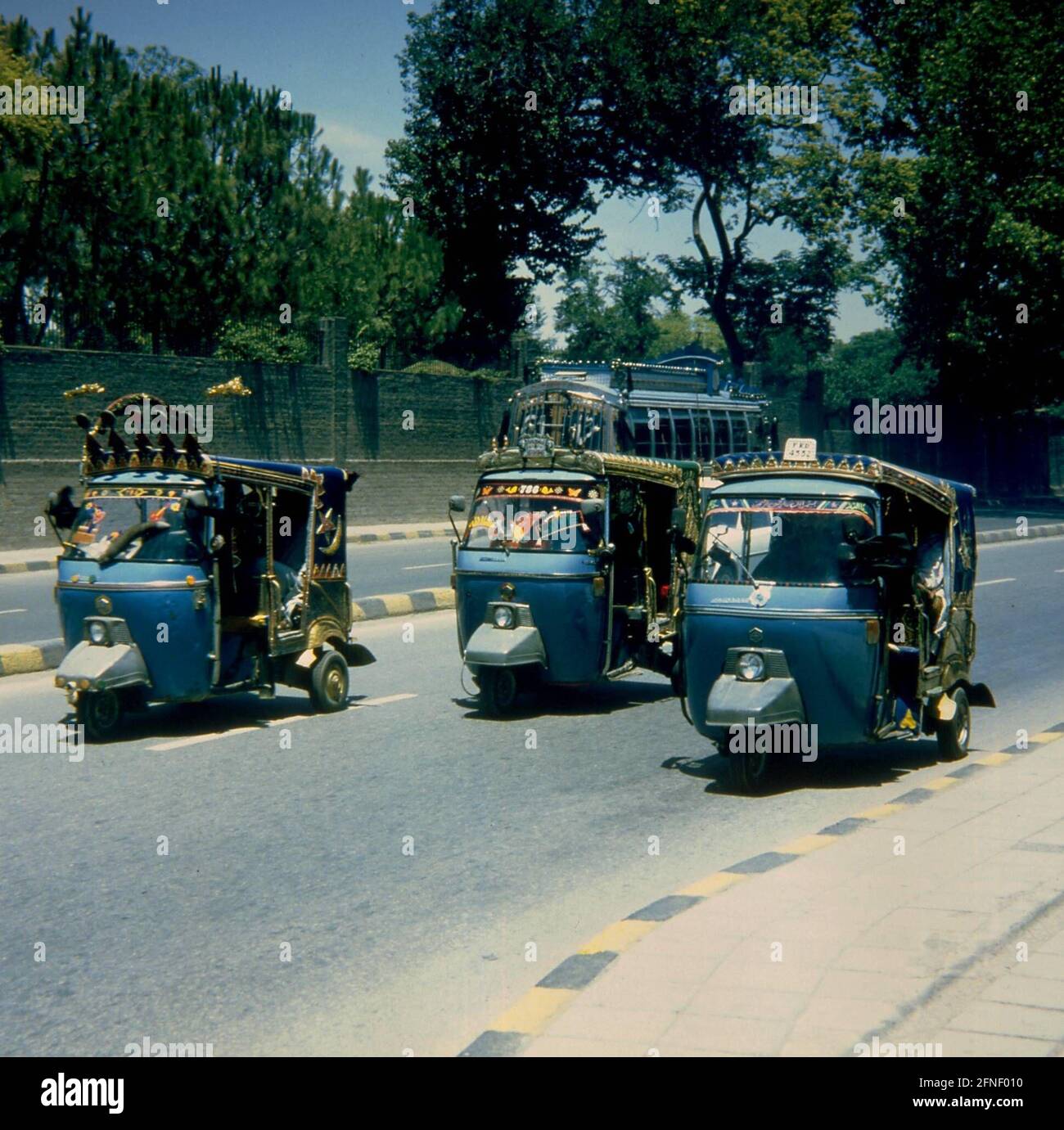 Three-wheeled motor rickshaws in Peshawar city traffic. [automated ...