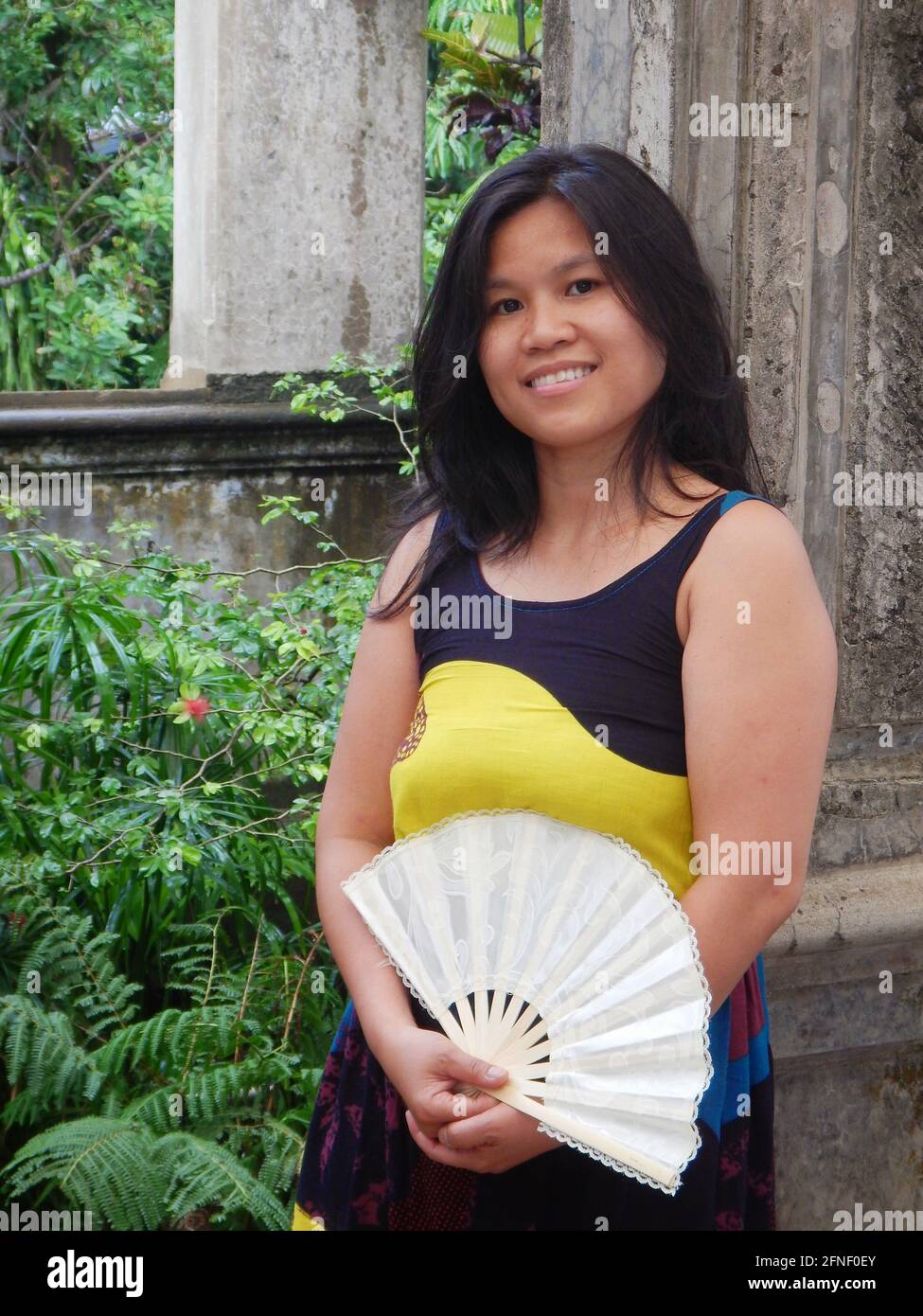 Young Asian Filipino woman posing with a fan at The Ruins, Bacolod ...